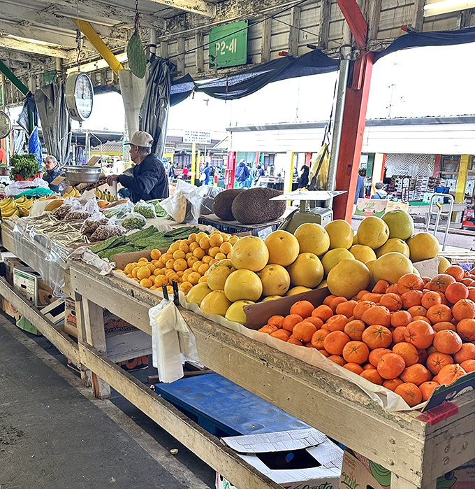 Citrus fruits pile high in wooden crates, looking fresher than your last grocery store haul and twice as photogenic.