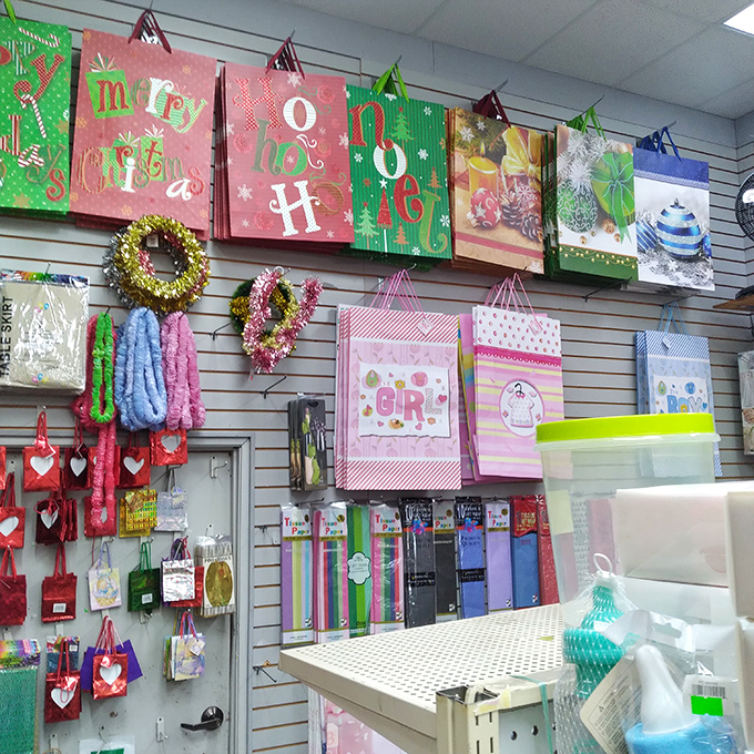 Gift bags galore hang like party bunting, proving you don't need deep pockets to wrap presents with style.