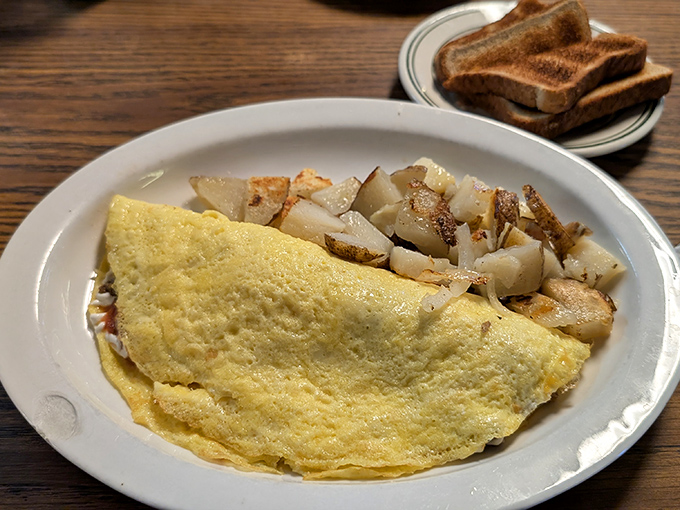 A perfect omelet that's achieved that elusive balance &ndash; fluffy yet substantial, paired with home fries crisped to golden-brown perfection. Breakfast nirvana exists!