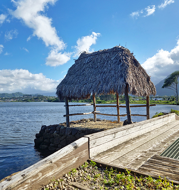 Traditional thatched shelters stand guard over ancient waters, connecting modern visitors to centuries of island wisdom.