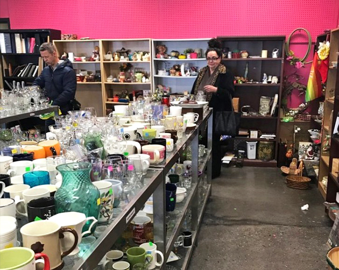 The glassware section gleams with potential, where vintage mugs and modern tumblers create a timeline of American drinking habits through the decades.