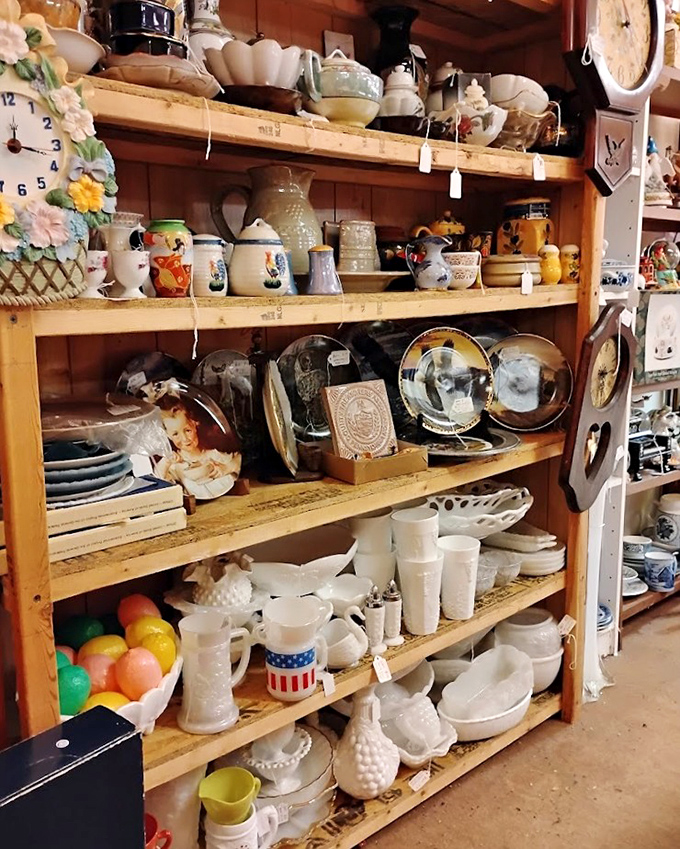 Grandma's kitchen comes alive on these wooden shelves, where milk glass mingles with patriotic mugs and serving pieces that have survived decades of family gatherings.