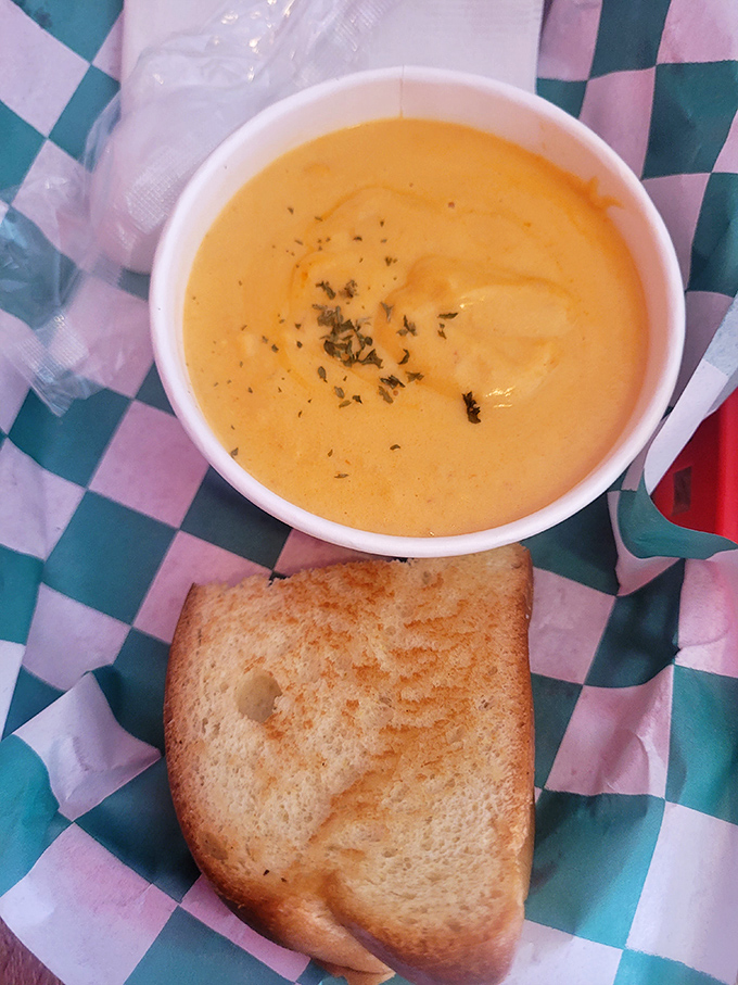 The bisque arrives like liquid gold in a simple white bowl. Paired with toast, it's the comfort food equivalent of a warm hug from the ocean.