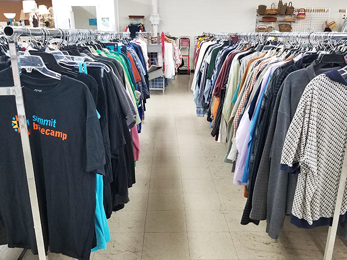 The men's clothing section stretches like a fabric highway, each hanger holding someone's past and another's future fashion statement.