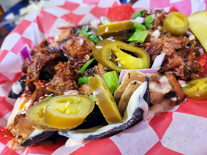 Hold onto your hats, these are not your average chips! Dive into this towering plate of savory, smoked meat nachos topped with fiery jalape&ntilde;os and creamy sauce.