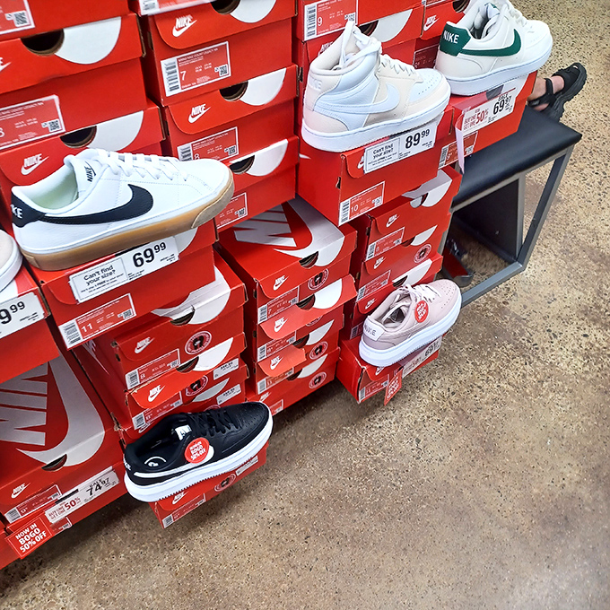 Nike boxes stacked like a sneakerhead's fever dream, where athletic footwear meets prices that won't require a second mortgage.