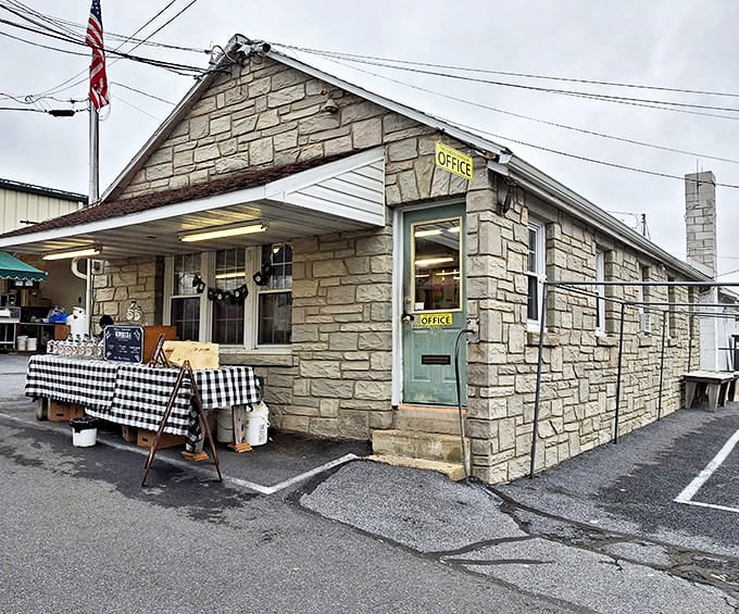 This unassuming stone office building, with its checkered tablecloth display, serves as command central for the organized chaos that is Green Dragon Market.
