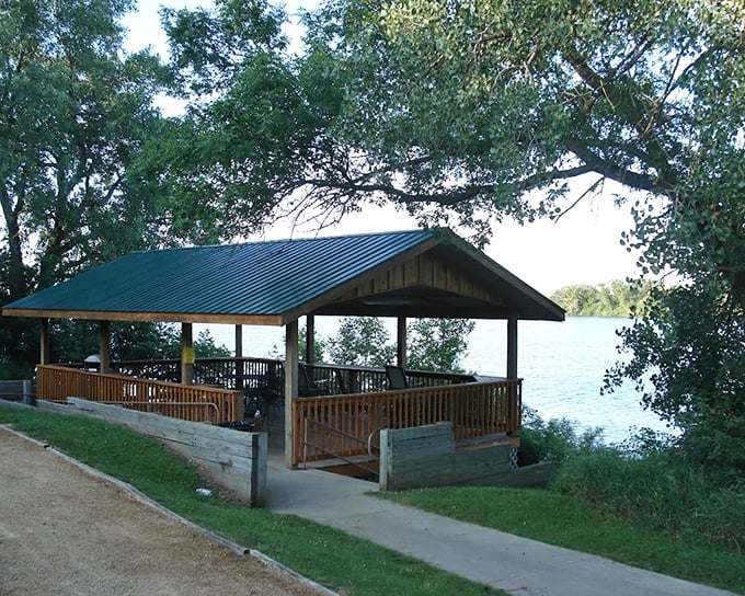 This lakeside shelter isn't just a roof&mdash;it's front-row seating to South Dakota's greatest show: sunset over calm waters.