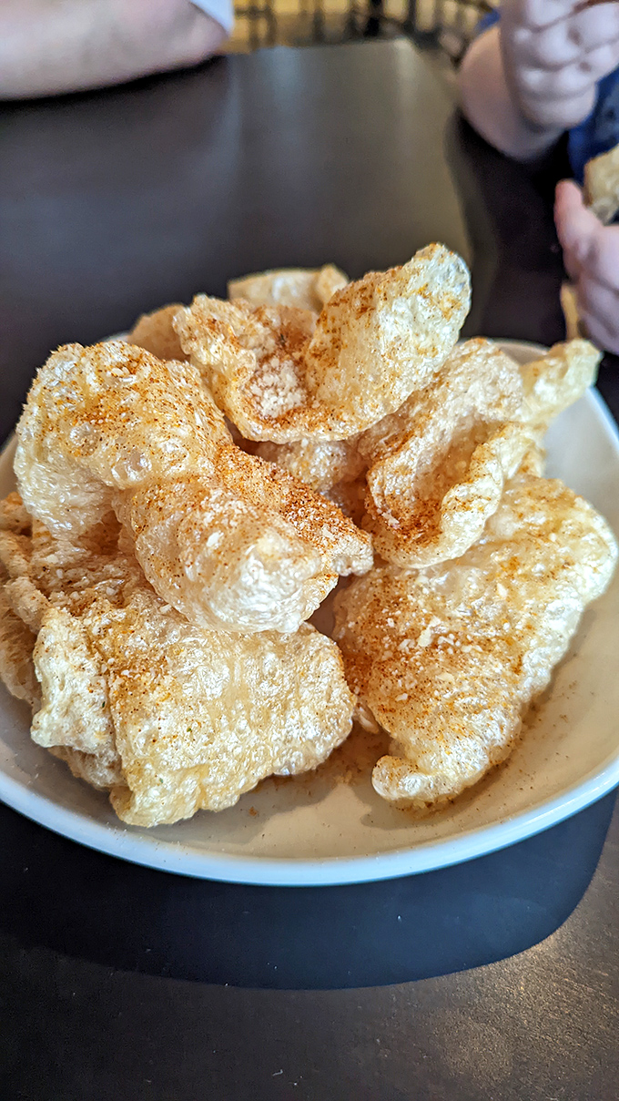 These aren't your gas station pork rinds &ndash; these airy, seasoned clouds practically dissolve on contact, leaving only flavor memories behind.