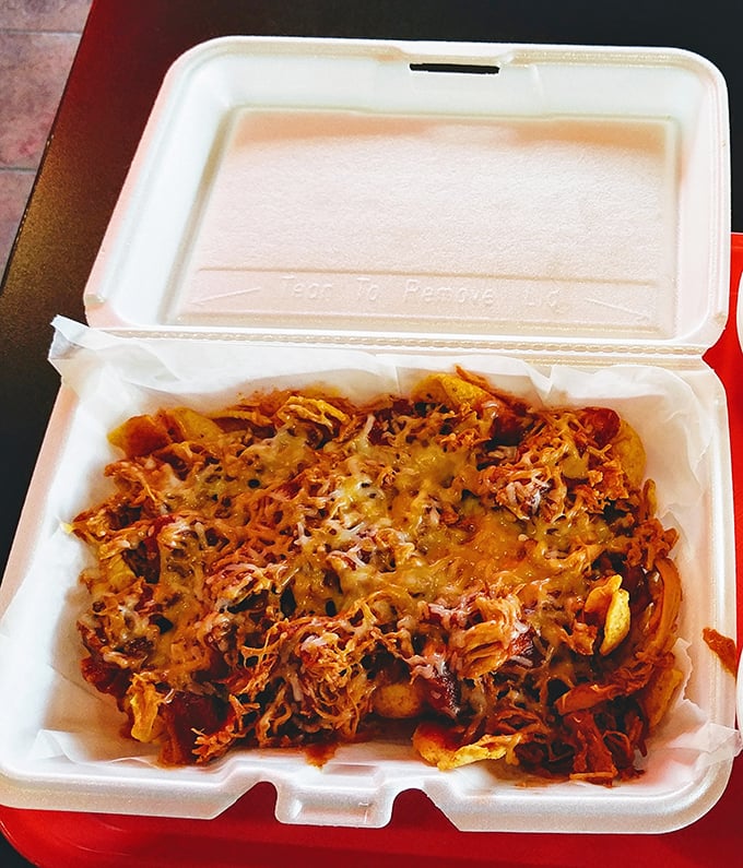 Pulled pork nachos that make you question why you've wasted time eating lesser versions. The cheese-to-meat ratio here is what mathematicians call "perfect."