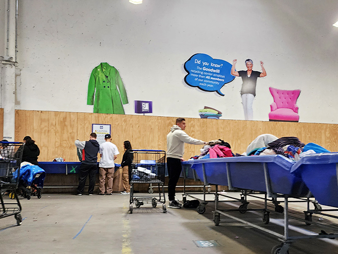 The thrill of the hunt in action! Shoppers strategically positioned around blue bins, like food critics waiting for the chef's special to arrive.