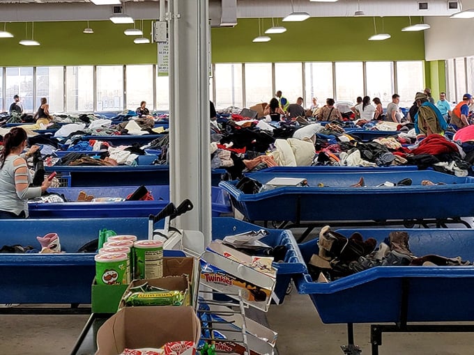 The true sport of thrifting in action. Notice the focused expressions – these aren't shoppers, they're archaeologists excavating modern artifacts with surgical precision.