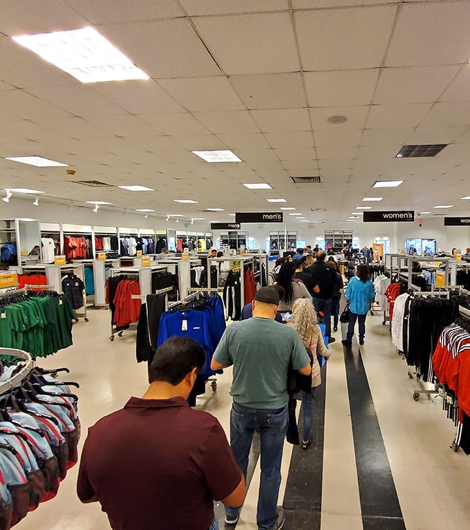 The shopping crowd moves with purpose and determination. Like salmon swimming upstream, but instead of spawning, they're hunting for 70% off designer labels.