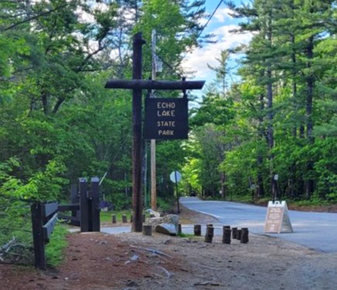 The rustic entrance sign stands sentinel, like a quiet friend saying, "Trust me, the view ahead is worth the trip."
