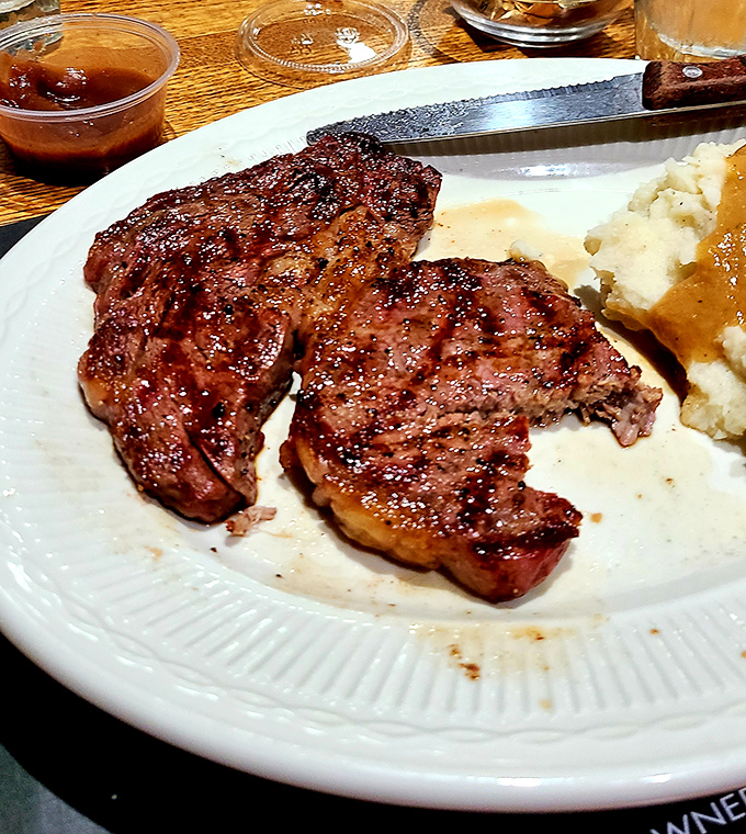 The sirloin arrives with that textbook crosshatch sear that whispers, "Someone in this kitchen really knows what they're doing."