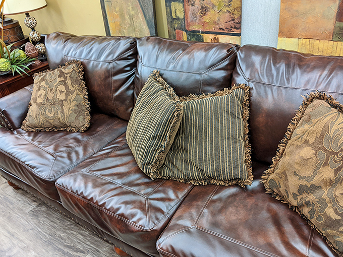 This leather sofa practically begs you to sink in with decorative pillows that add character money can't buy.
