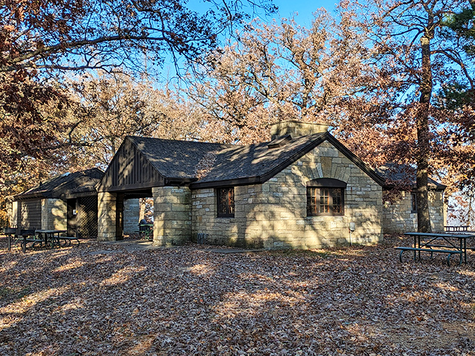 The CCC-built stone shelter stands ready for picnickers. Depression-era craftsmanship that puts modern "assembly required" furniture to absolute shame.