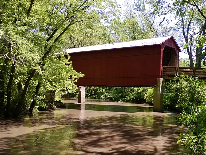 After heavy rains, Sugar Creek shows its muscle beneath the bridge, a reminder that these structures were built to withstand nature's mood swings.