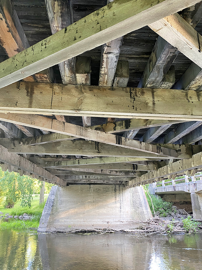 Look up! The bridge's underside reveals ingenious engineering—wooden beams interlaced without nails, a forgotten art of American craftsmanship.