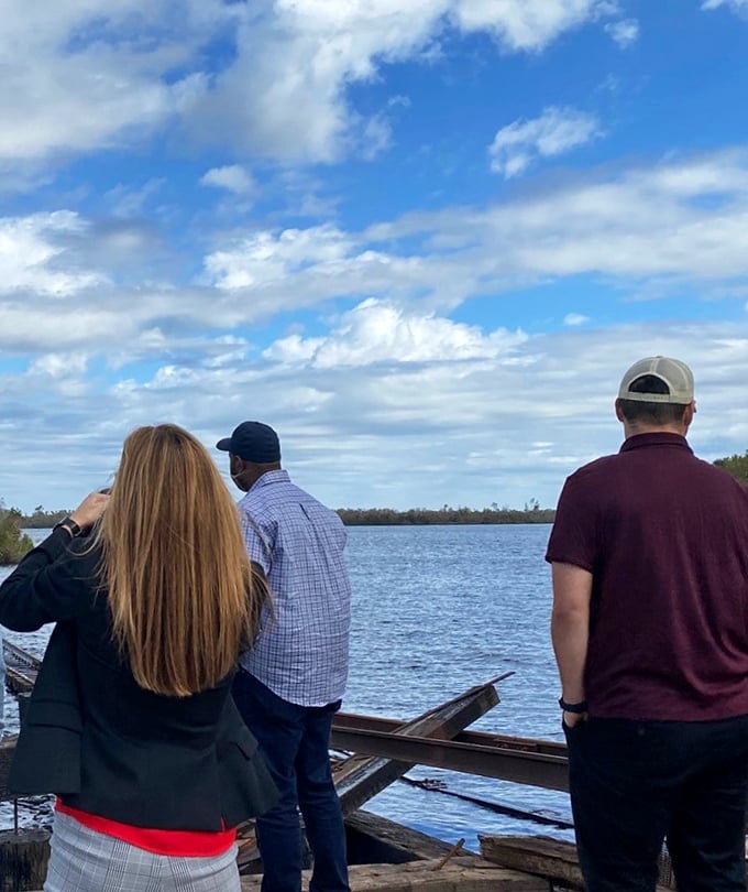 Fellow travelers take in the waterfront views, proving that sometimes the best vacation moments happen when you're standing still. 