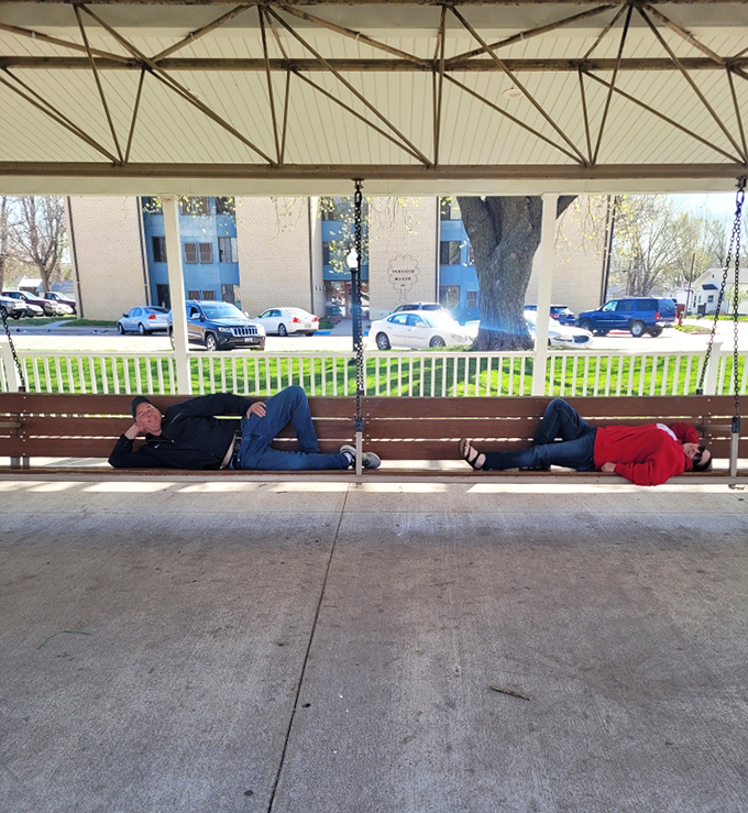 "We're going to need more people." Two visitors demonstrate the comical scale of Hebron's famous swing, designed for 24 adults but accommodating imaginations of any size.
