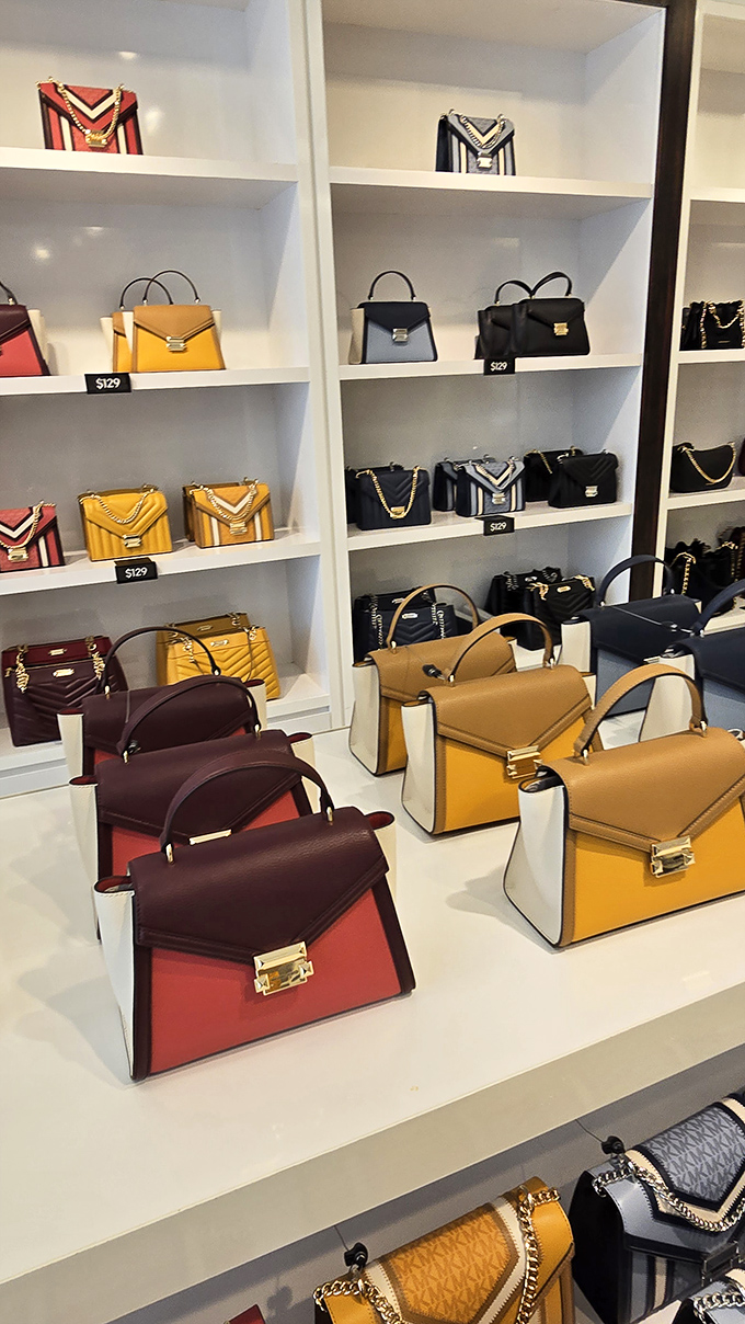 Luxury handbags line pristine shelves like precious gems, offering designer dreams at surprisingly accessible outlet prices.