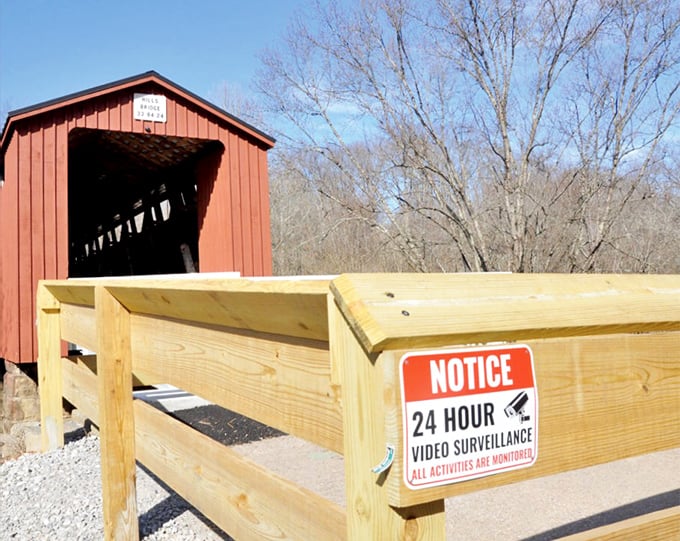 Modern meets historic at the entrance—that surveillance sign is the 21st century's way of saying "please respect this 19th-century treasure."