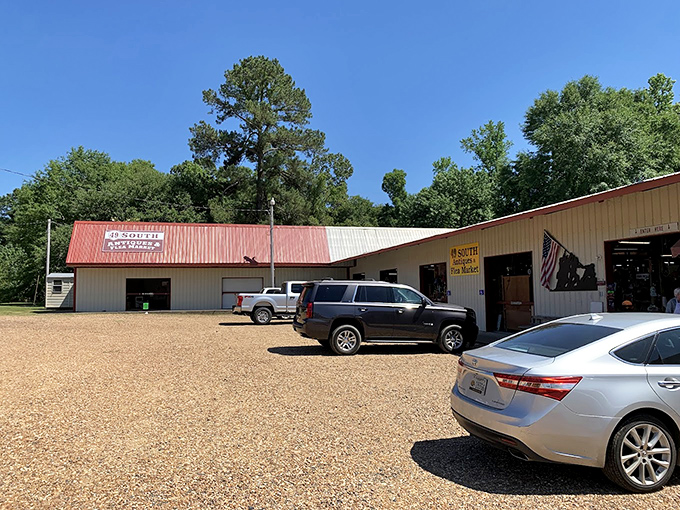 49 South Antiques & Flea Market sits under a classic red roof in Florence, its wide-open storefronts and gravel lot welcoming treasure hunters pulling in for a browse.