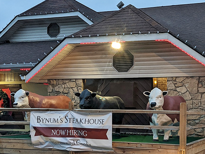 The distinctive roofline and clean white exterior mark the spot where neighborhood steak magic happens every single evening.
