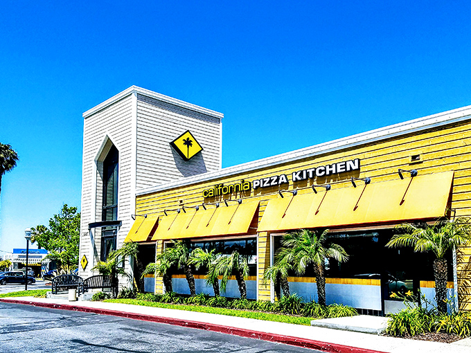 California Pizza Kitchen's bright yellow facade brings a splash of sunshine to Long Beach, where coastal breezes meet creative crusts.