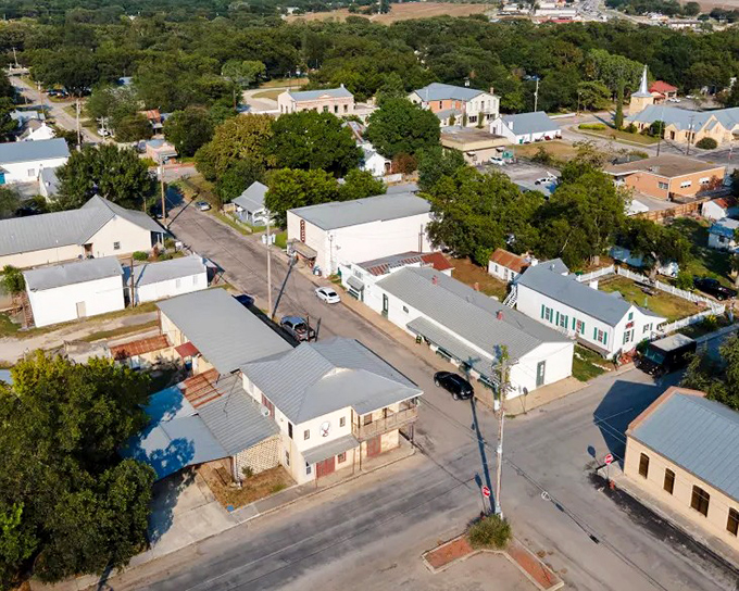 A bird's-eye view of Castroville reveals its charming layout, where Alsatian heritage blends with Texas hospitality among tree-lined streets.