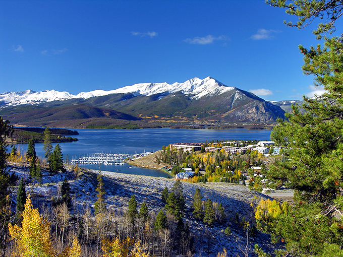 Snow-capped mountains stand guard over sapphire waters dotted with sailboats. Mother Nature showing off again!