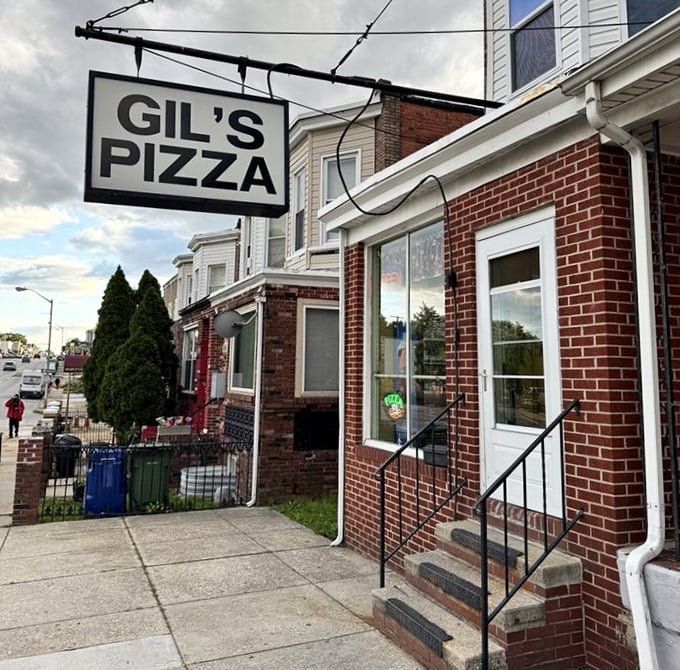 Gil's simple black sign doesn't need fancy graphics when the pizza inside speaks louder than words. 