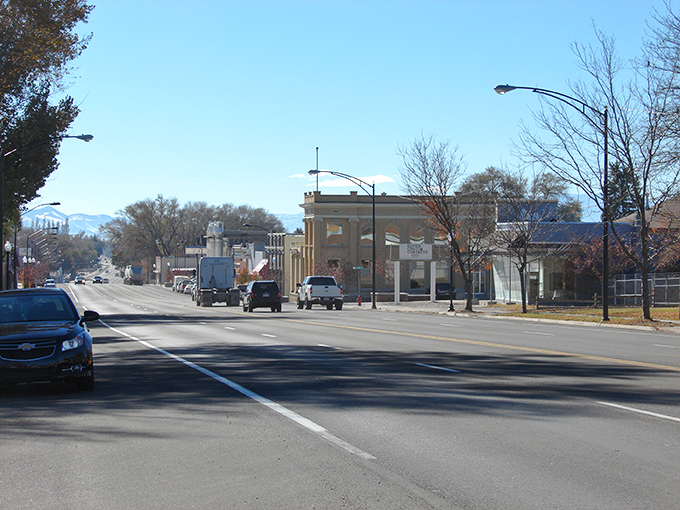 Gunnison's main street invites you to slow down and notice the mountains framing this peaceful town where rush hour means three cars at a stop sign.
