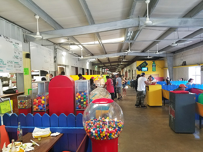 Colorful booths, cheerful shoppers and bright gumball machines create a lively scene inside J and J Flea Market in Athens.