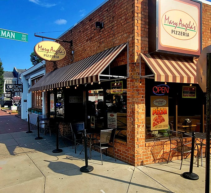 Those classic striped awnings and brick walls scream "authentic neighborhood pizzeria" in the most wonderful way possible.