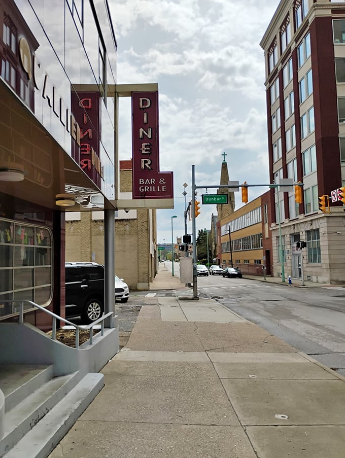 The Quarrier Diner sign stands tall like a beacon for breakfast lovers navigating Charleston's historic streets and hungry hearts.