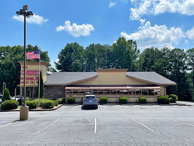 The Diner at Sugar Hill stands proudly under blue skies, promising breakfast that's worth saluting alongside that American flag.