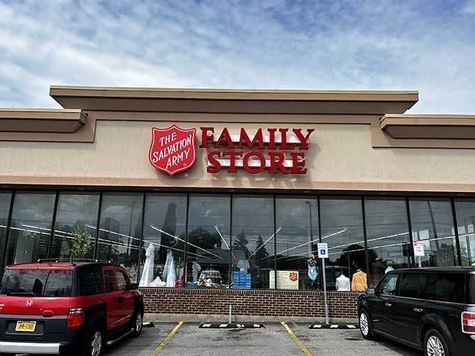 Salvation for your wallet under the red shield! This Rochester thrift emporium reflects clouds and possibilities in equal measure across its welcoming windows.