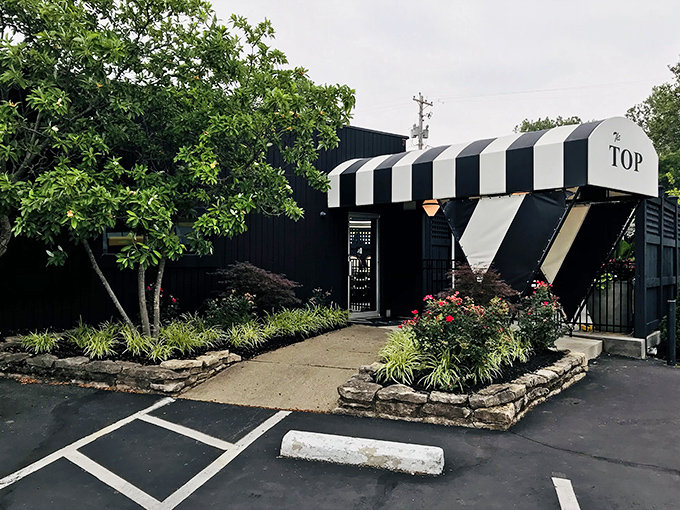 The Top's classic black and white awning – like a tuxedo for a building that takes steak very seriously.