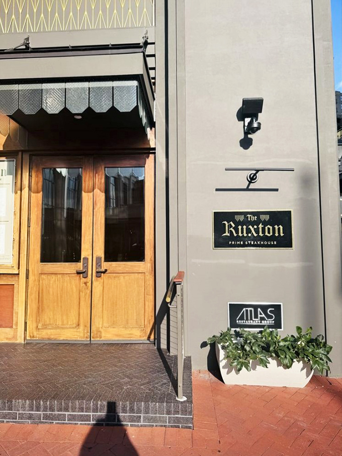 Those elegant wooden doors open to reveal a steakhouse experience that feels like discovering a secret society.