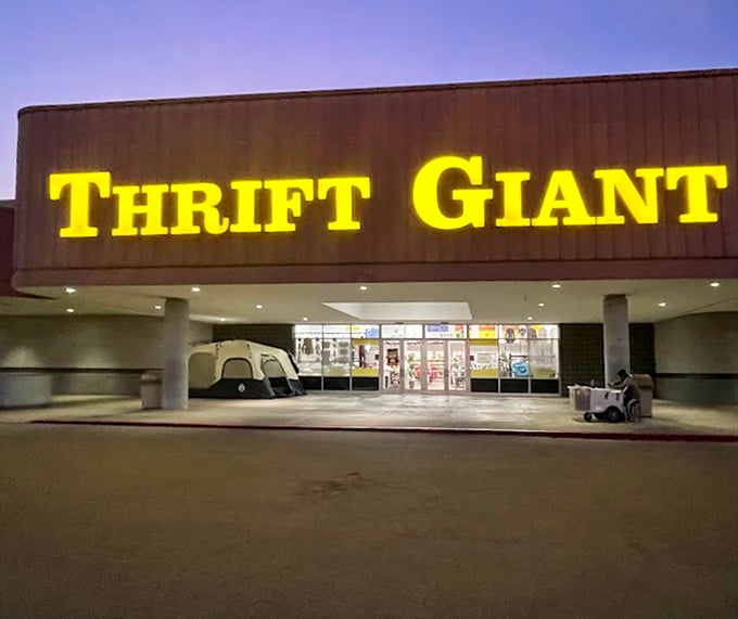 Thrift Giant's illuminated yellow sign glows like a beacon for night owls seeking last-minute treasures.
