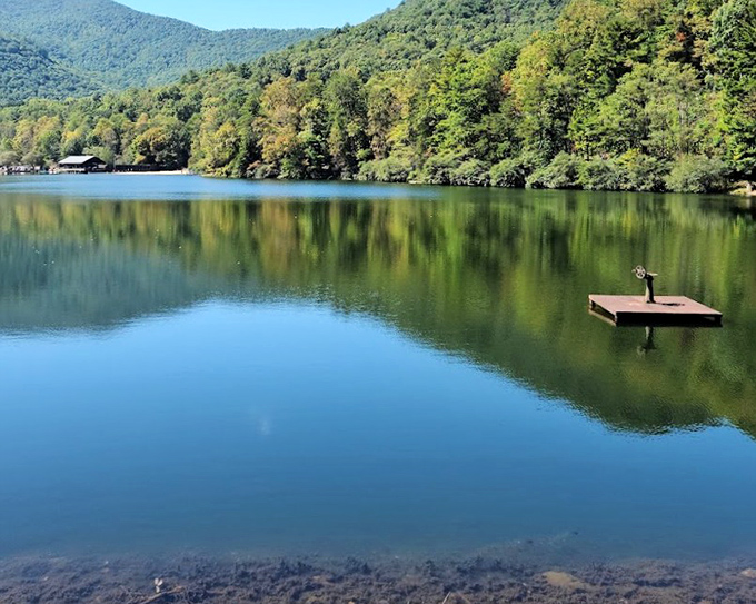 Mirror-like waters at Vogel State Park reflect mountain majesty. A lone fishing dock invites quiet contemplation in this Blairsville haven.
