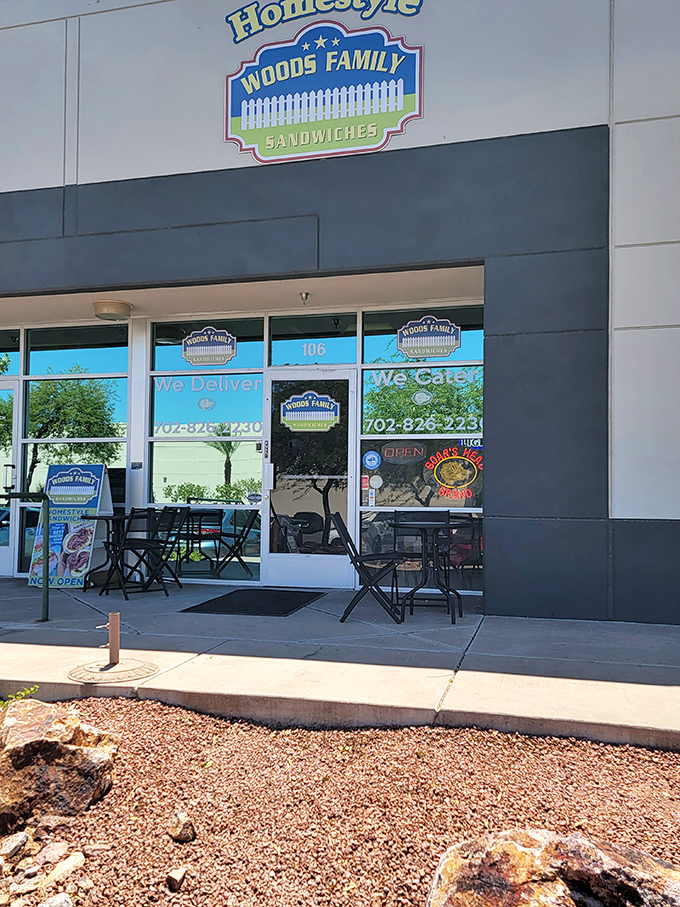 Woods Family Sandwiches' cheerful blue sign and white picket fence logo &ndash; Norman Rockwell meets lunch hour.