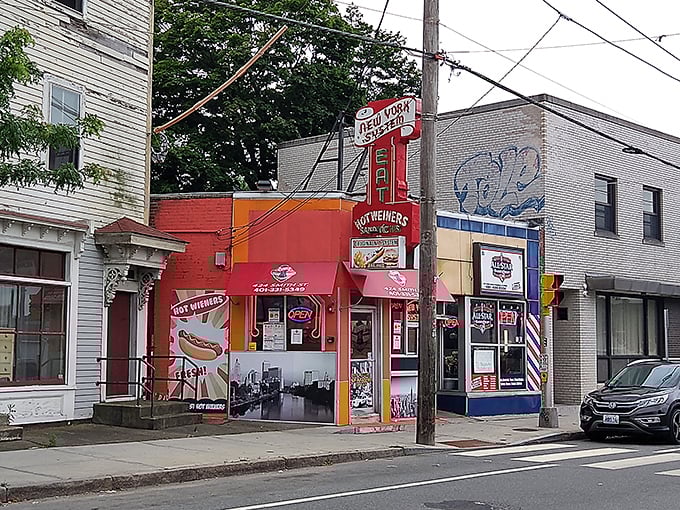 The vibrant orange storefront practically shouts "authentic Rhode Island wieners served here!"