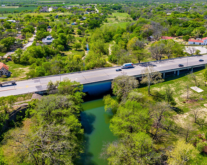 The Medina River flows peacefully alongside Castroville, creating a natural oasis where locals have gathered for generations.