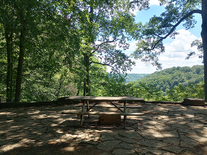 Sunlight dapples the stone patio, inviting you to sit down and soak up the vast, uninterrupted view of the valley.