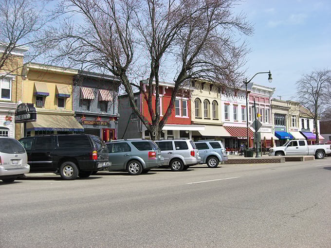 Winter-bare trees frame Granville's colorful storefronts, where retirement dollars stretch further than those awnings over the sidewalk.