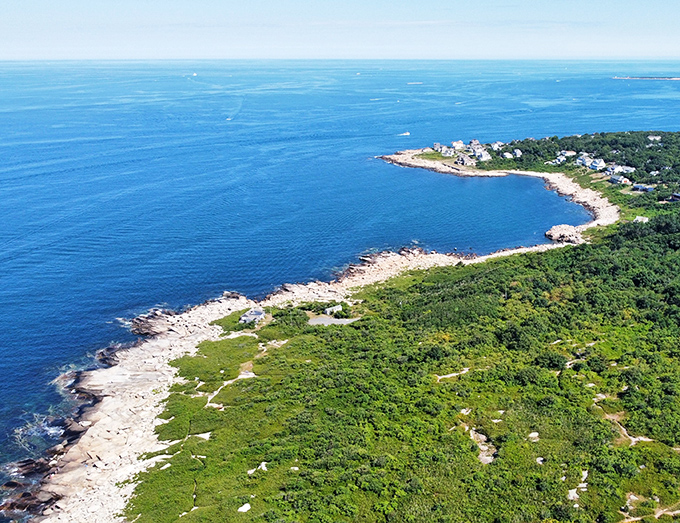 A powerful panorama of natural coastline, where the land yields slowly to the deep blue sea.