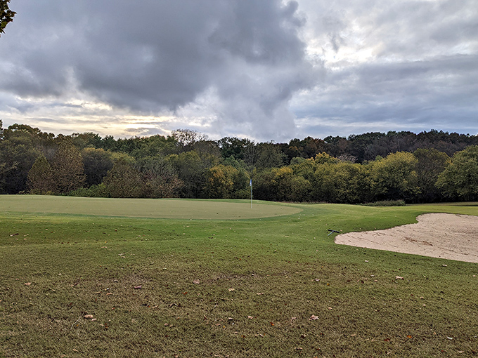 The golf course stretches out under moody skies, daring you to improve your game while the clouds threaten to improve your pace.